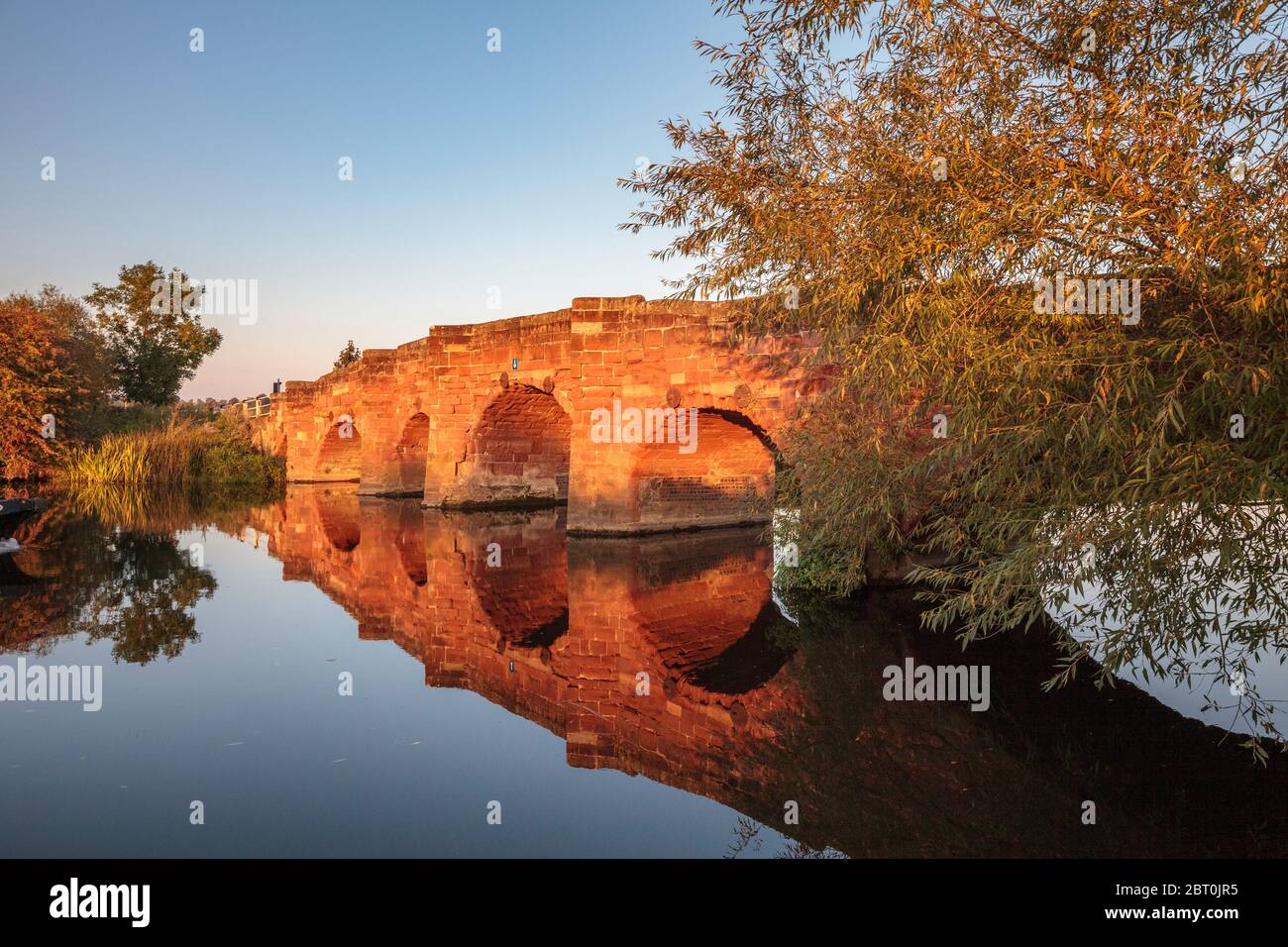 A sunset view of the historic sandstone bridge over the Avon at ...
