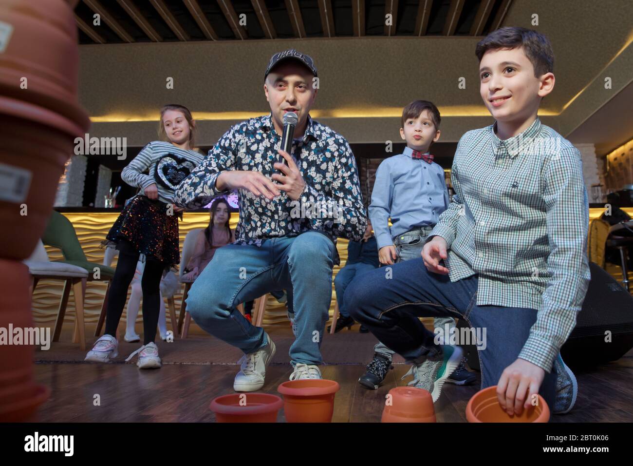 children play a race to stack a bowl on top of each other. Kids Playing ...