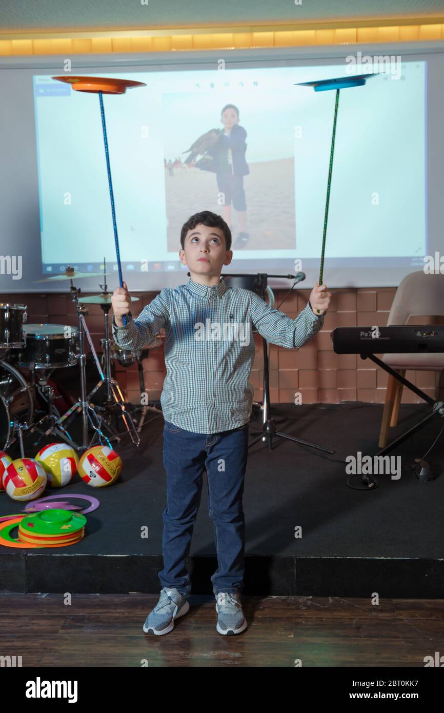Child spinning white, blue, plates . Fun with Spinning Plates ...