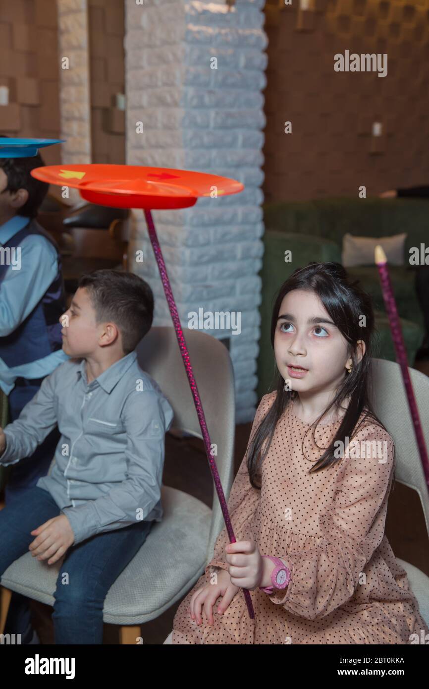 Child spinning white, blue, plates . Fun with Spinning Plates ...