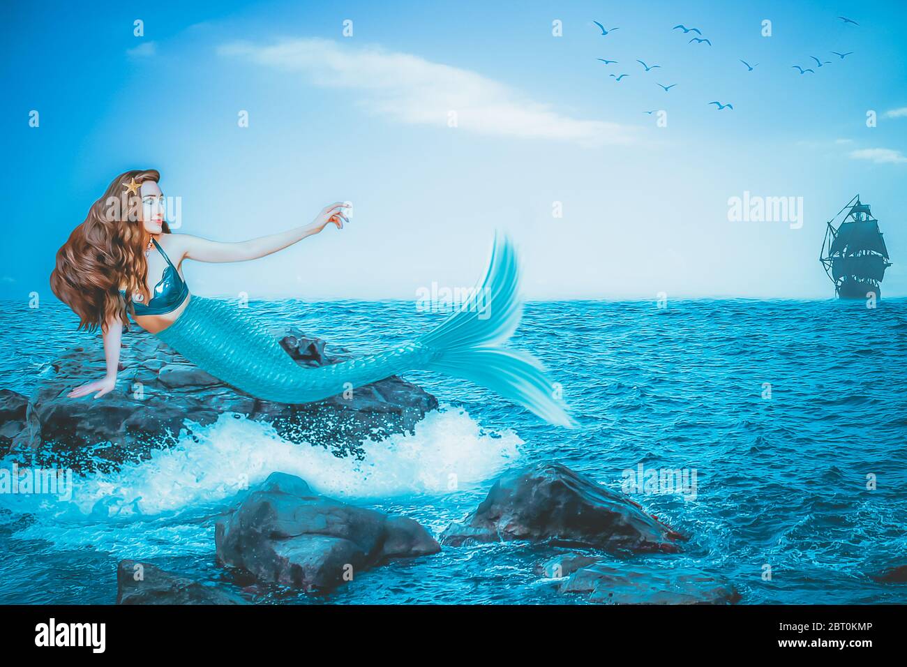 Beautiful mermaid on the stone in the blue sea closeup. Art processing ...