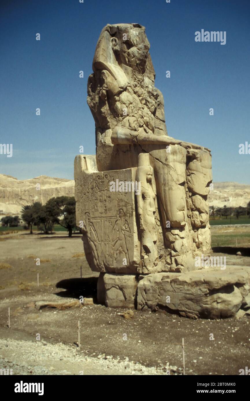 The southern Colossi of Memnon statue of the Pharaoh Amenhotep III in ...