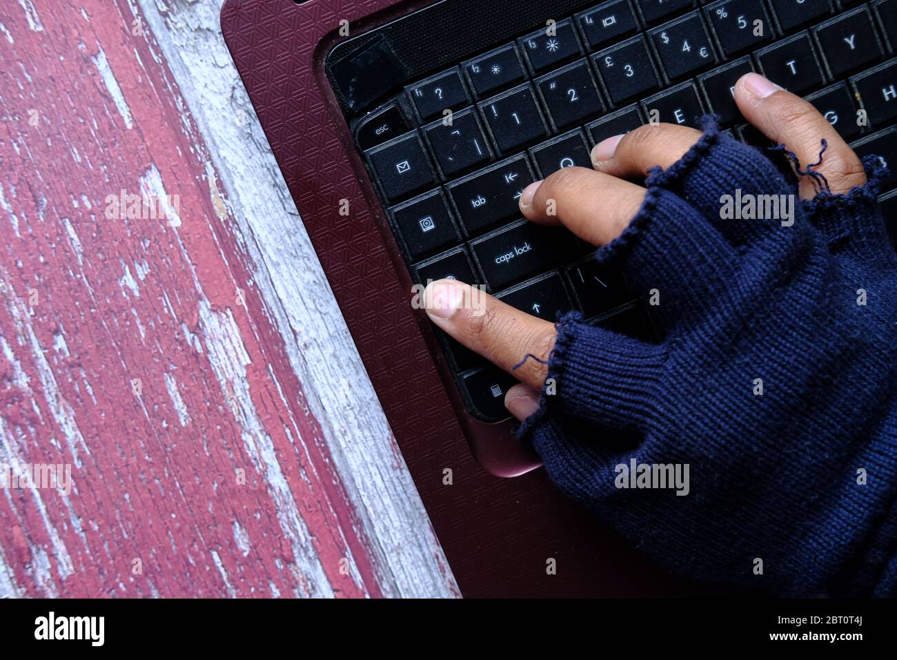 hacker hand typing on laptop stealing data Stock Photo - Alamy