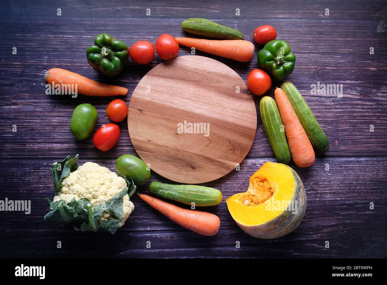 Healthy food selection with vegetables and empty chopping board on ...