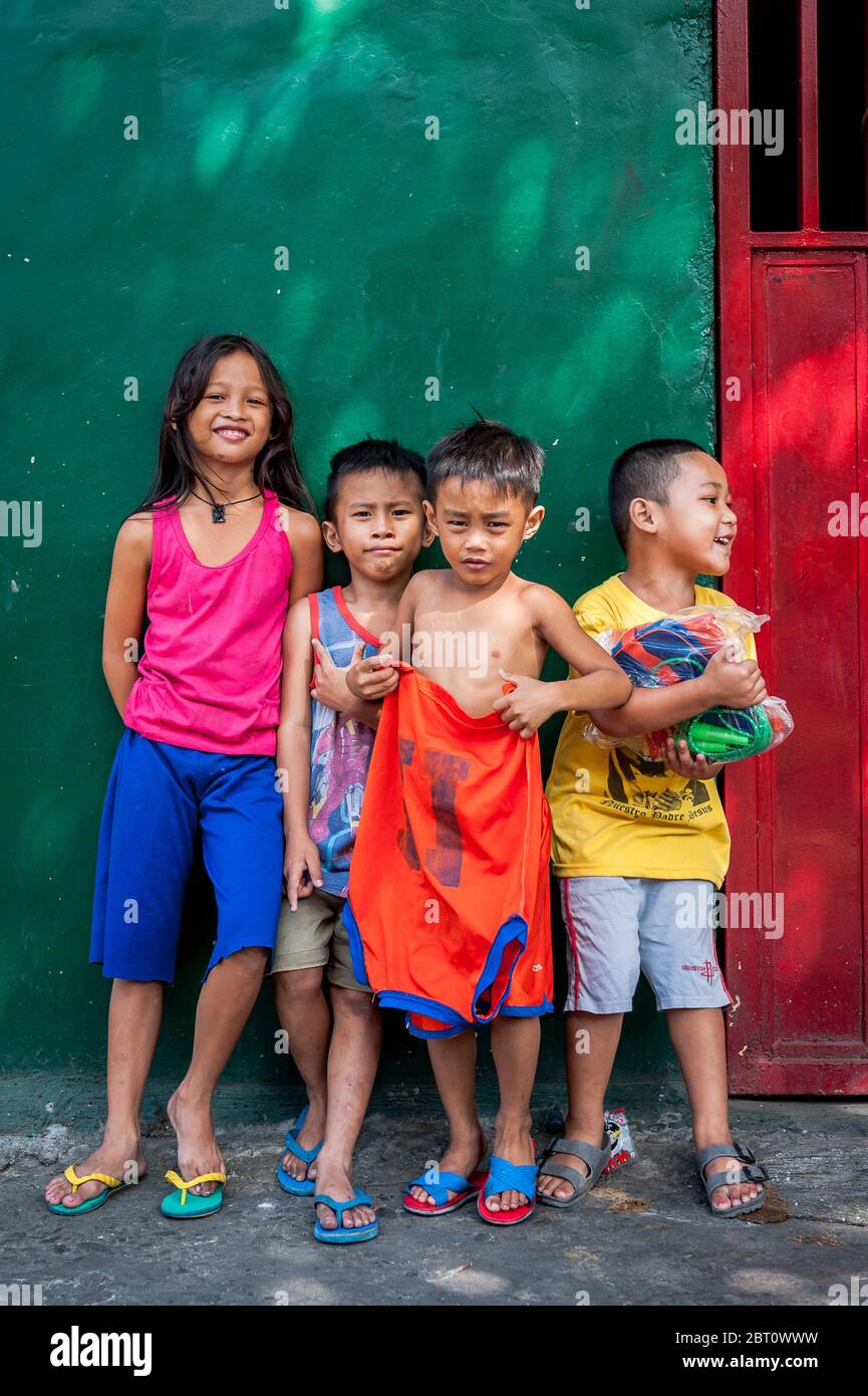 A pretty young Filipino girl and her friends pose and smile for my camera in the old walled city ...