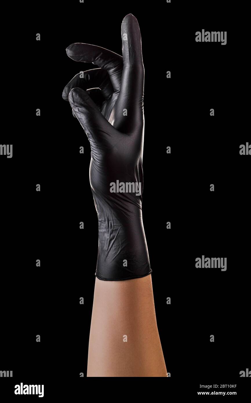 Hand in black gloves with the index finger pointing up on black Stock ...