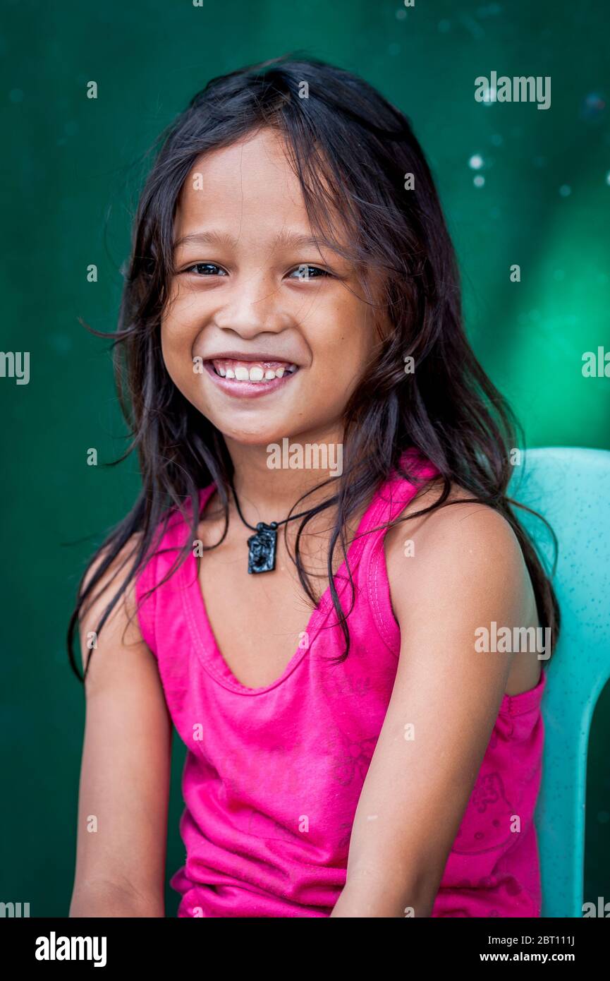 A pretty young Filipino girl poses and smiles for my camera in the old ...