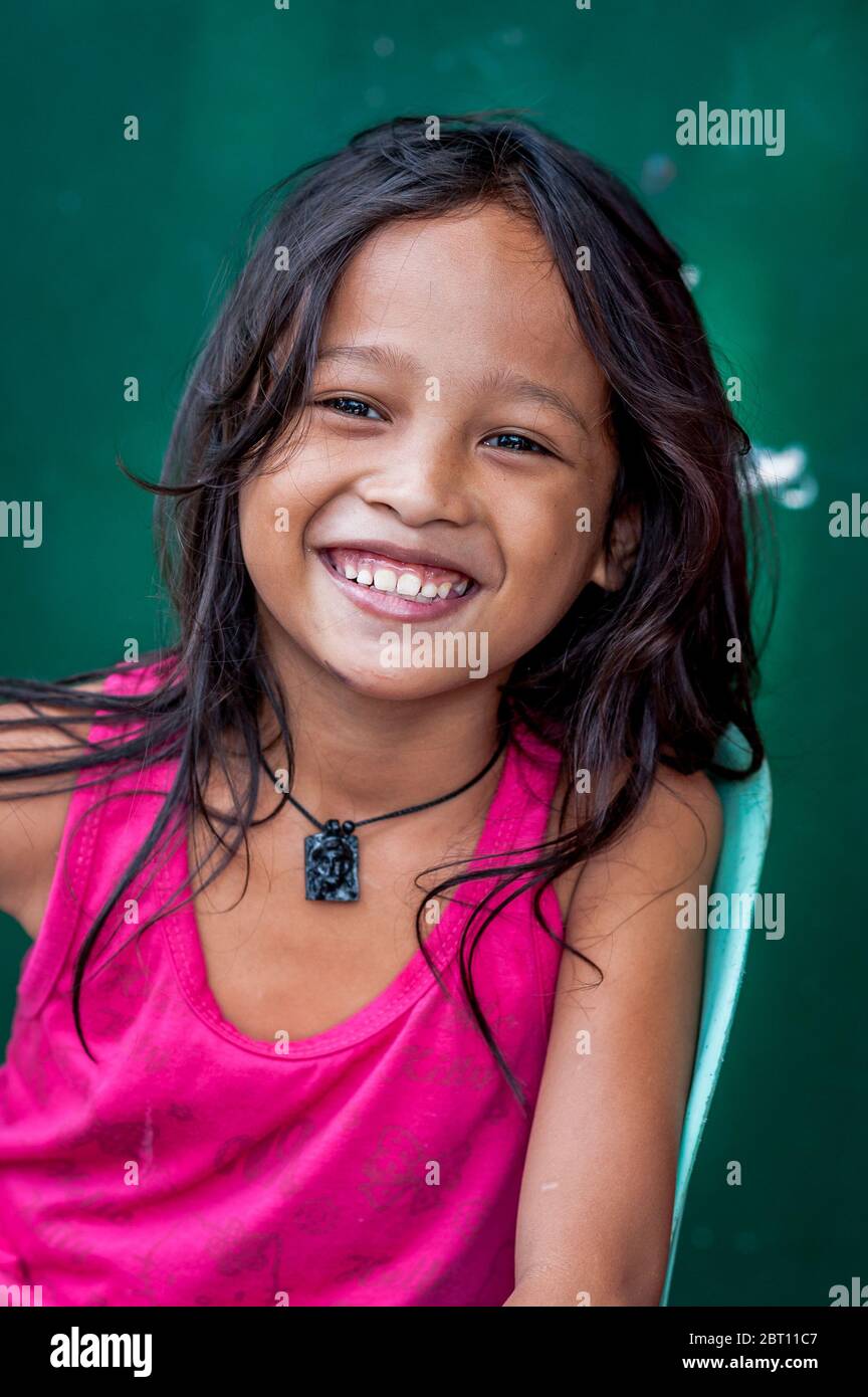 A pretty young Filipino girl poses and smiles for my camera in the old ...