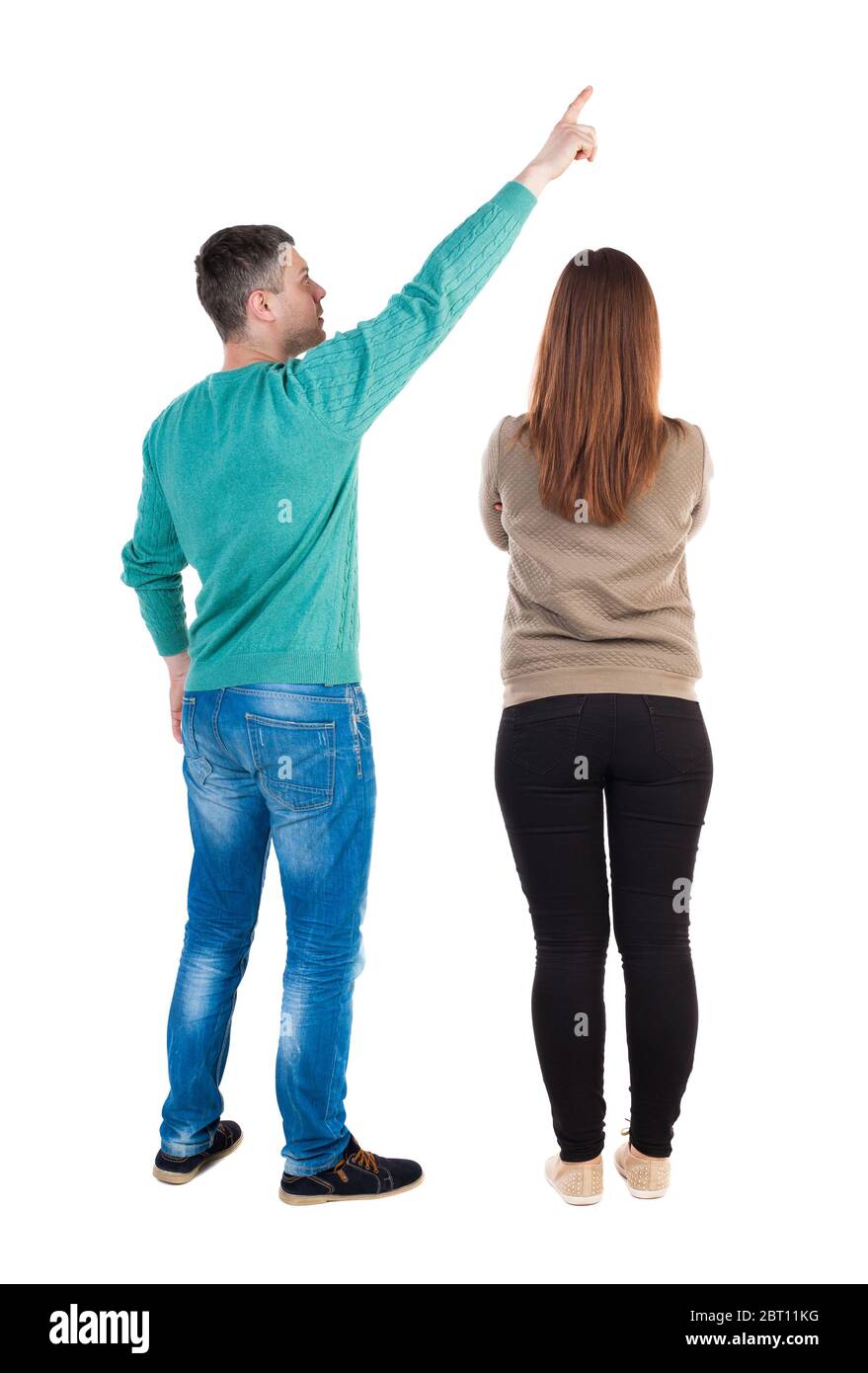 Back view of couple in sweater pointing. Rear view people collection ...