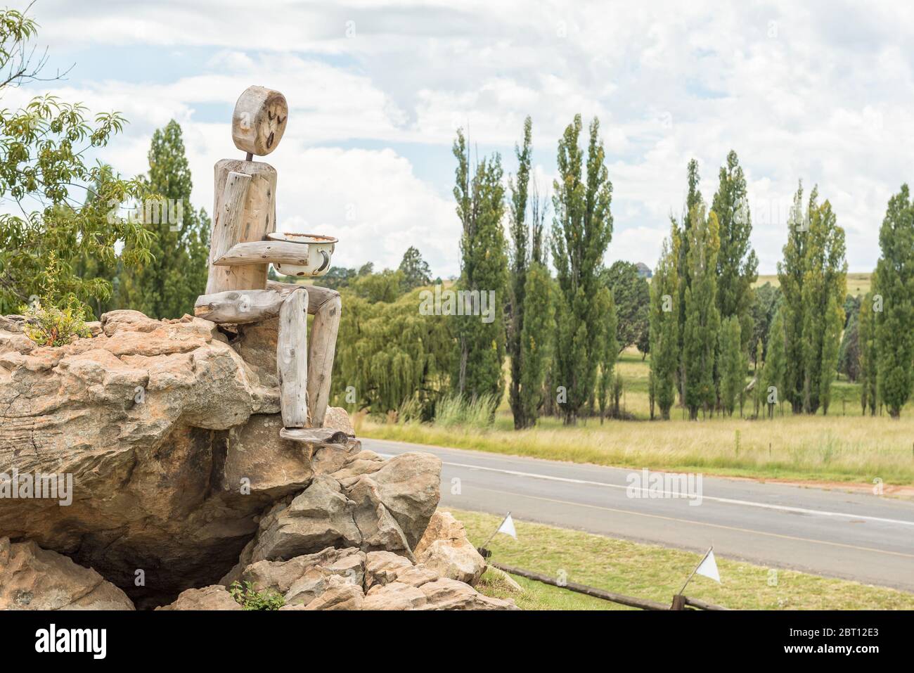 CLOCOLAN, SOUTH AFRICA - MARCH 20, 2020: A wooden log man next to road ...