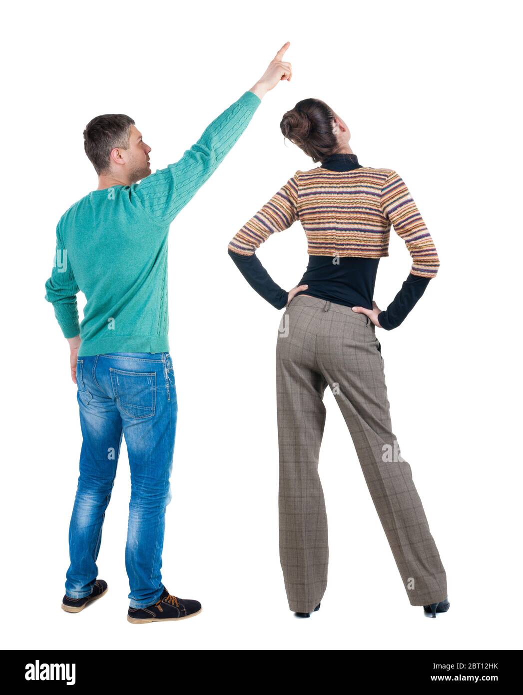 Back view of couple in sweater pointing. Rear view people collection ...