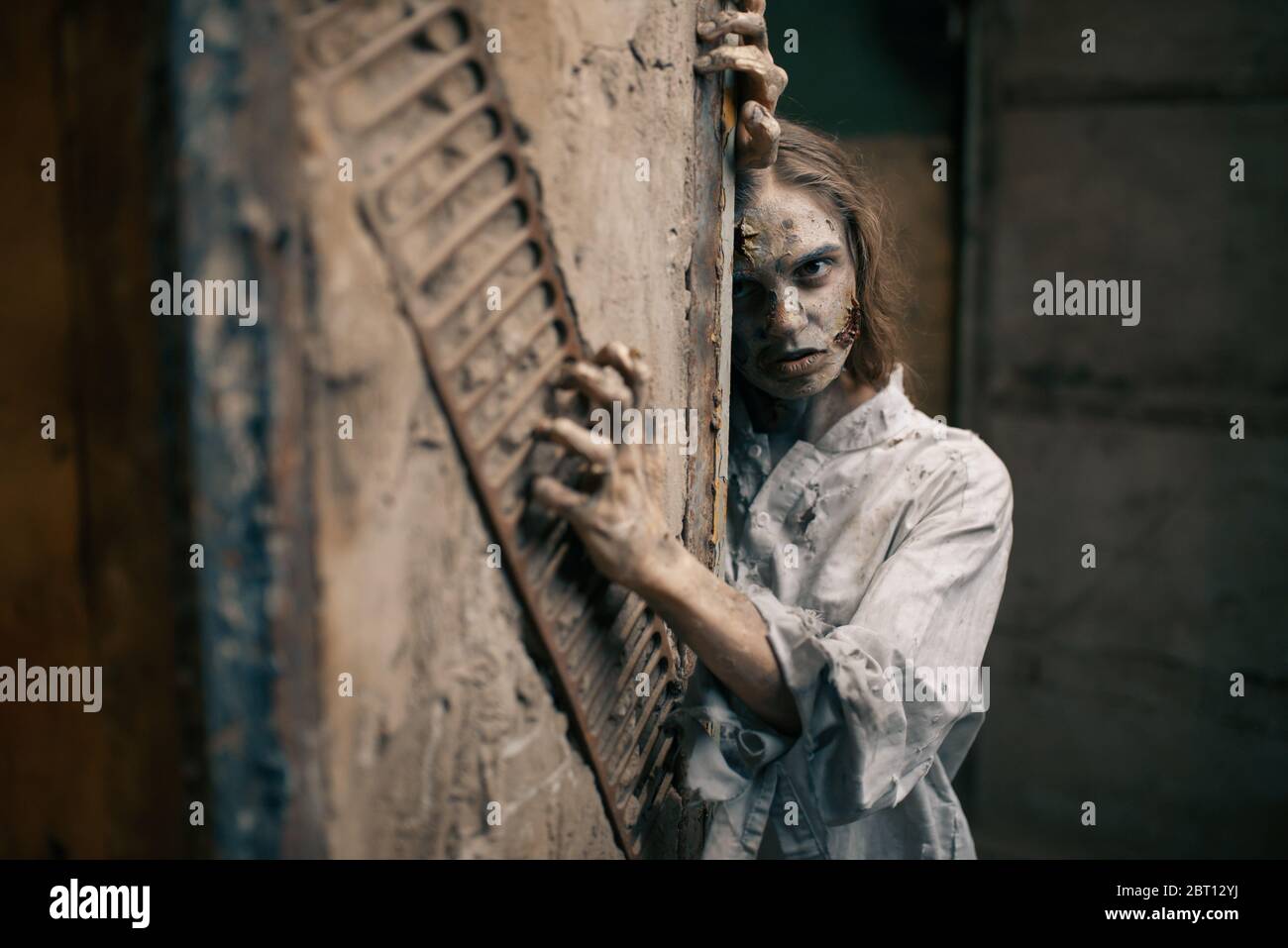 Female zombie in abandoned factory, devil. Horror in city, creepy ...