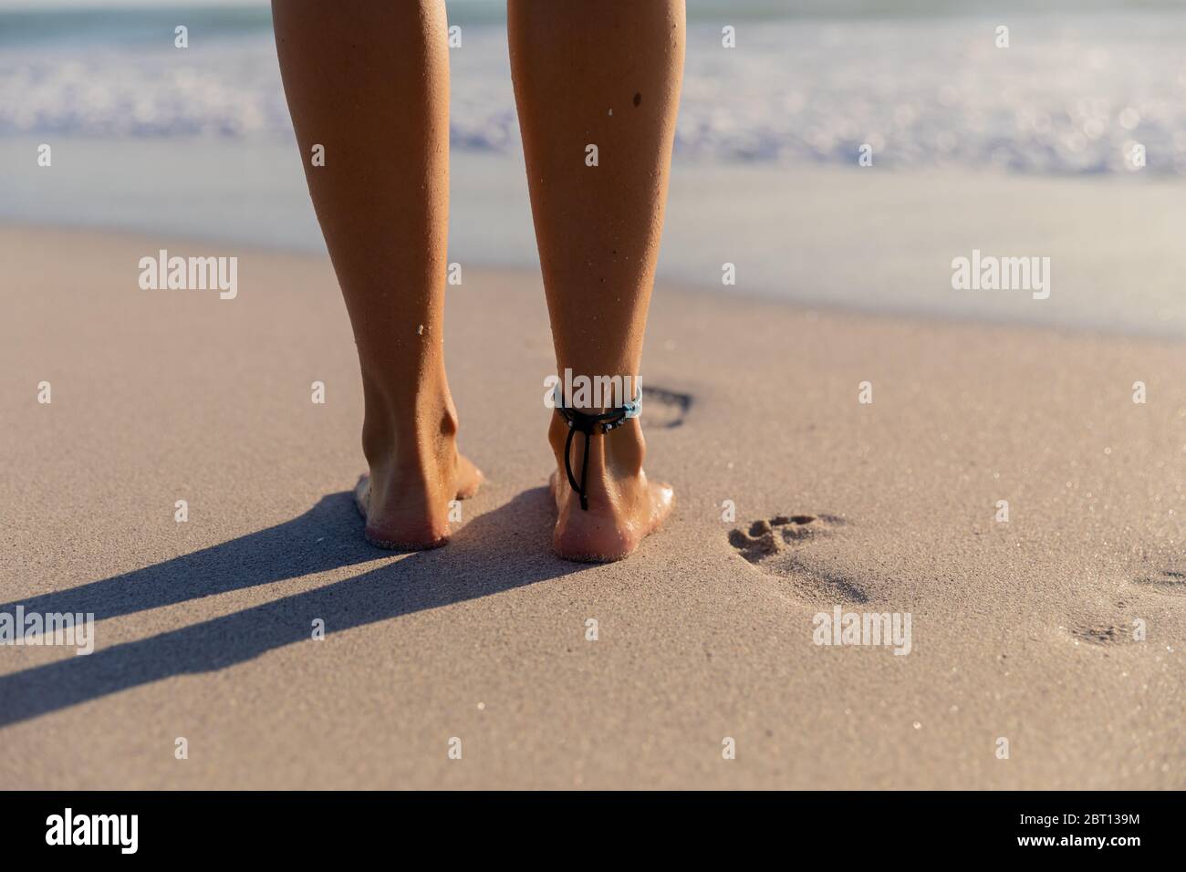 Woman walking towards beach hi-res stock photography and images - Alamy