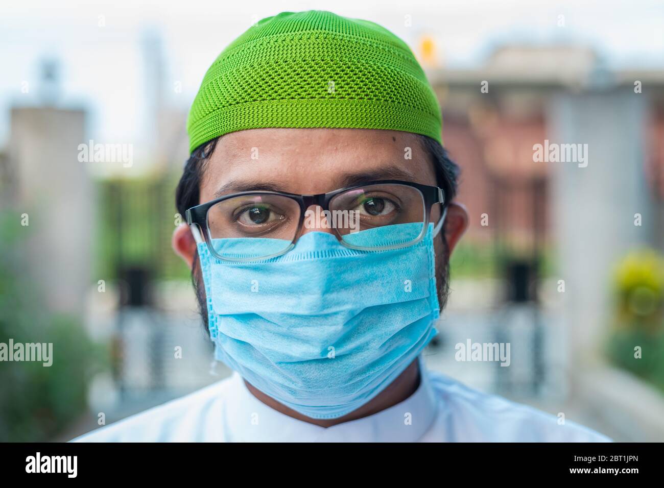 Closeup Asian Muslim man in traditional attire with face mask Stock ...