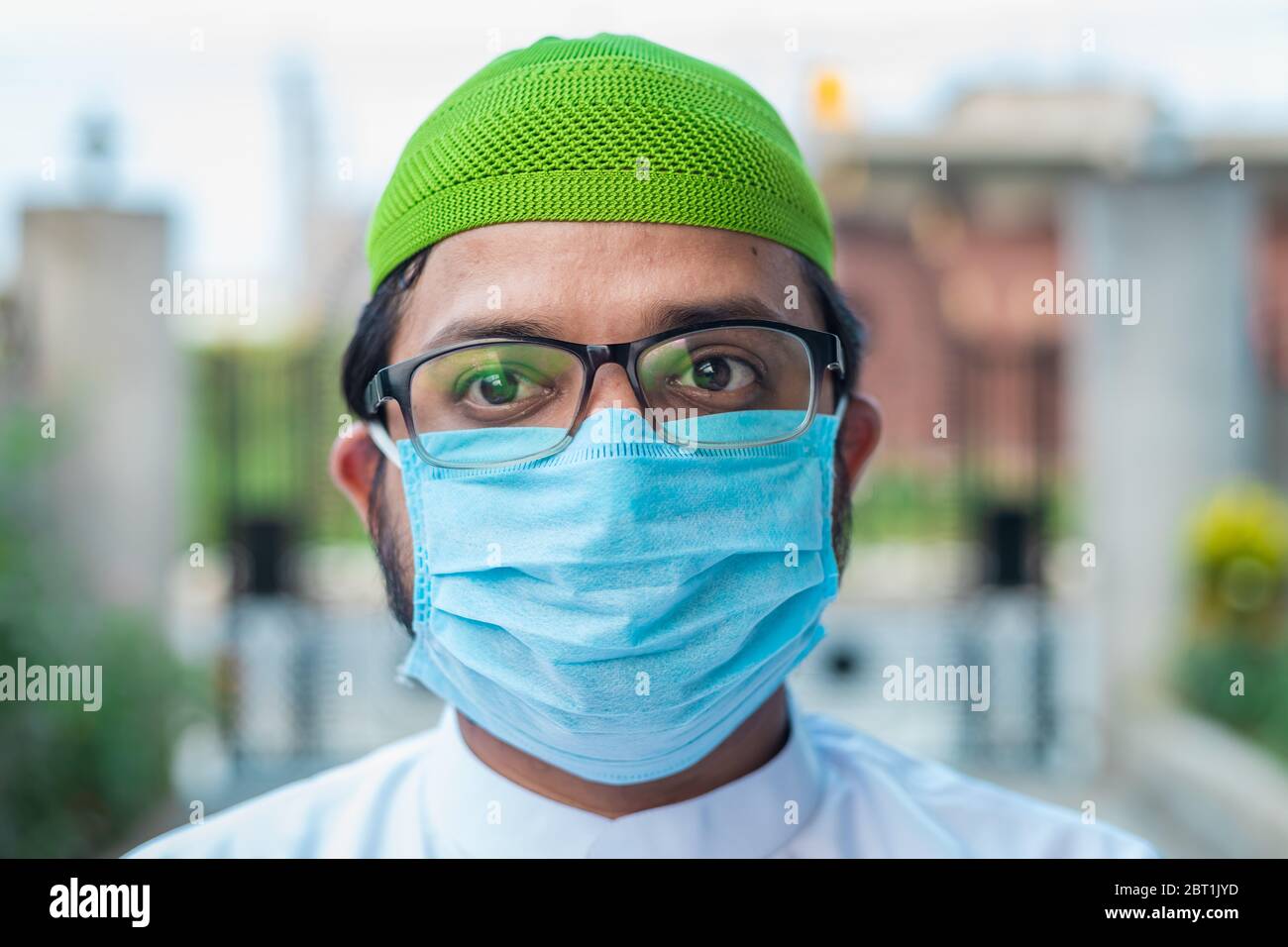 Closeup Asian Muslim man in traditional attire with face mask Stock ...