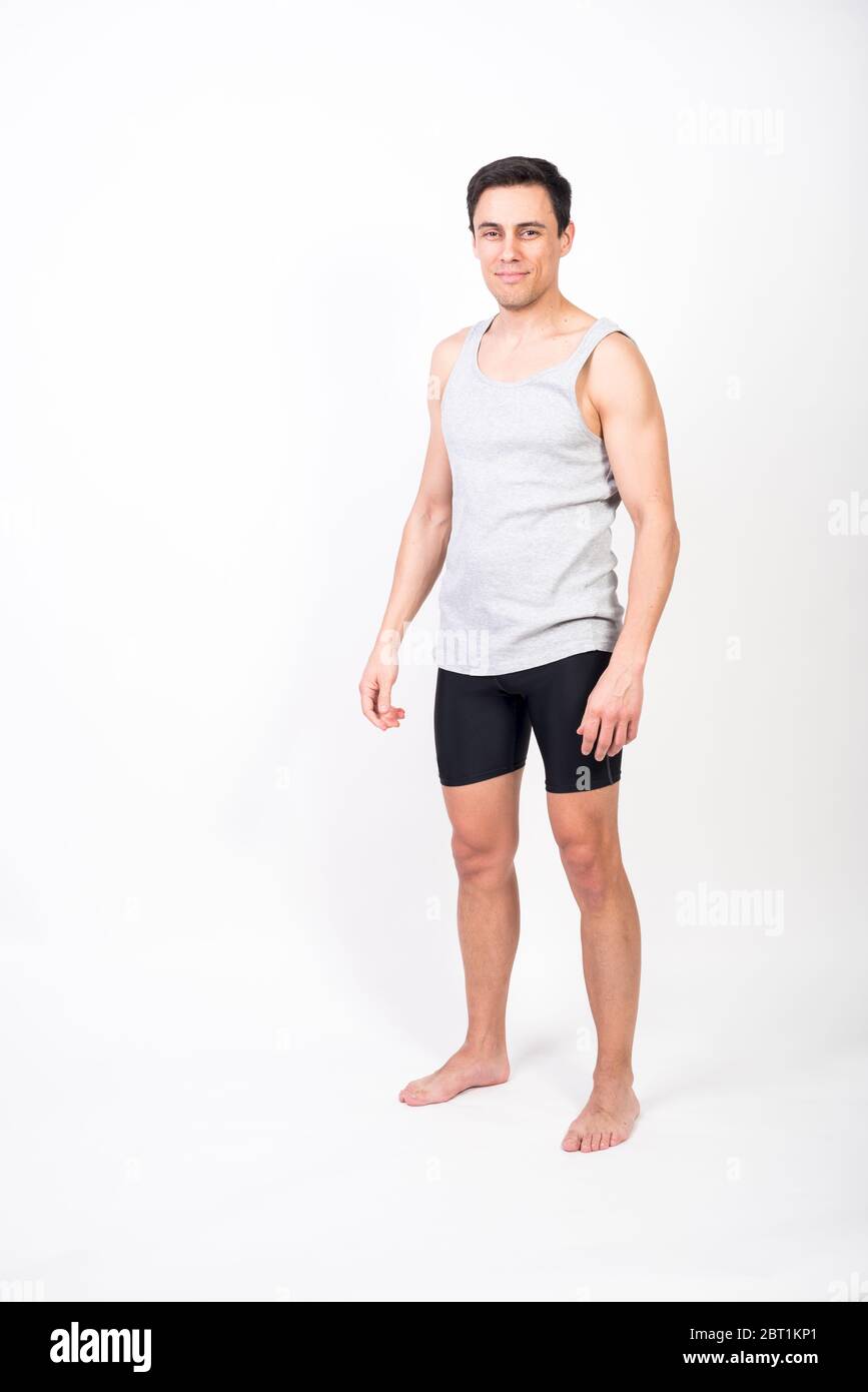 Man with sportswear standing looking at camera smiling. White ...