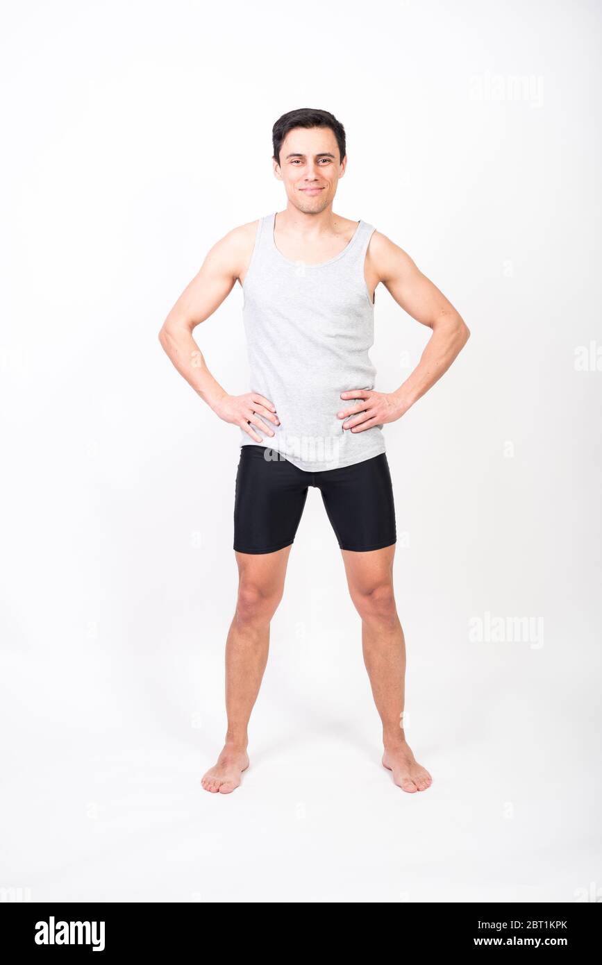 Man with sportswear standing looking at camera smiling. White ...