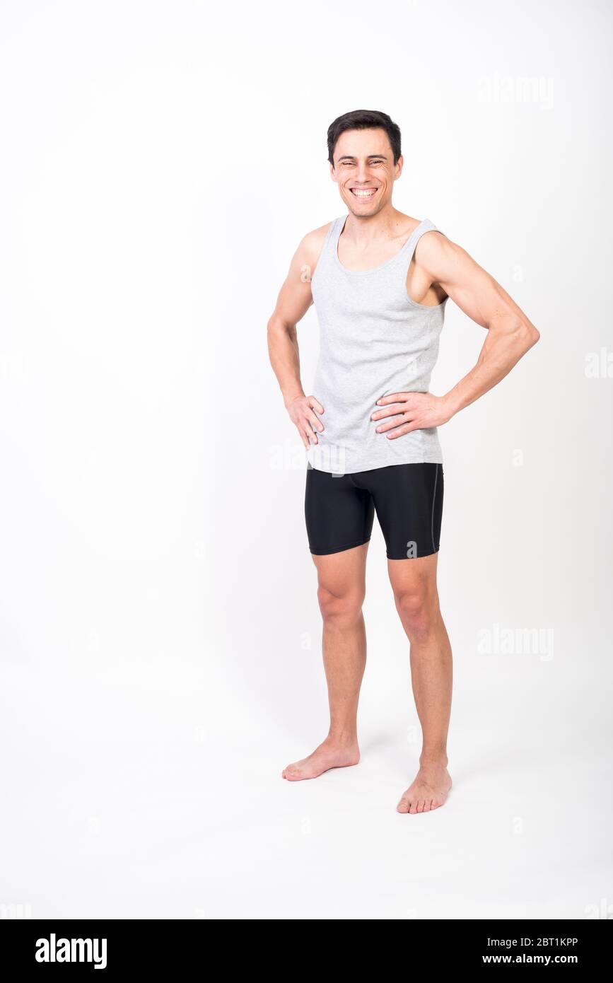 Man with sportswear standing looking at camera smiling. White ...