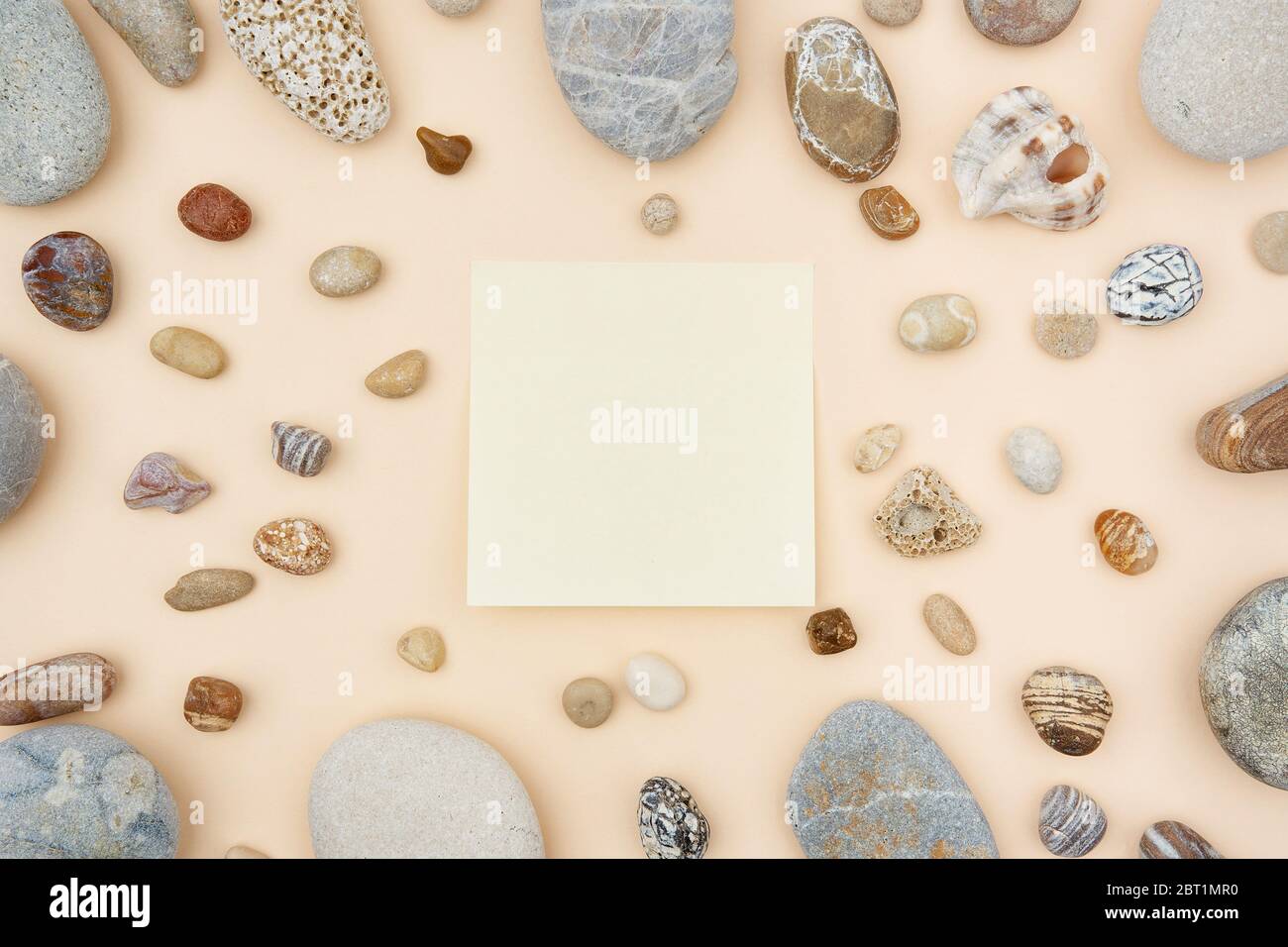 Sticky notes in the middle of mix of rounded multicolor textured stones ...