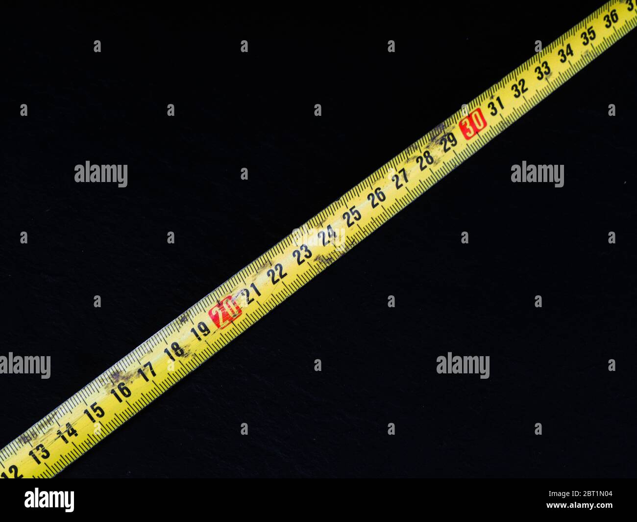 coronavirus icons as facial mask and folding meter on black background ...