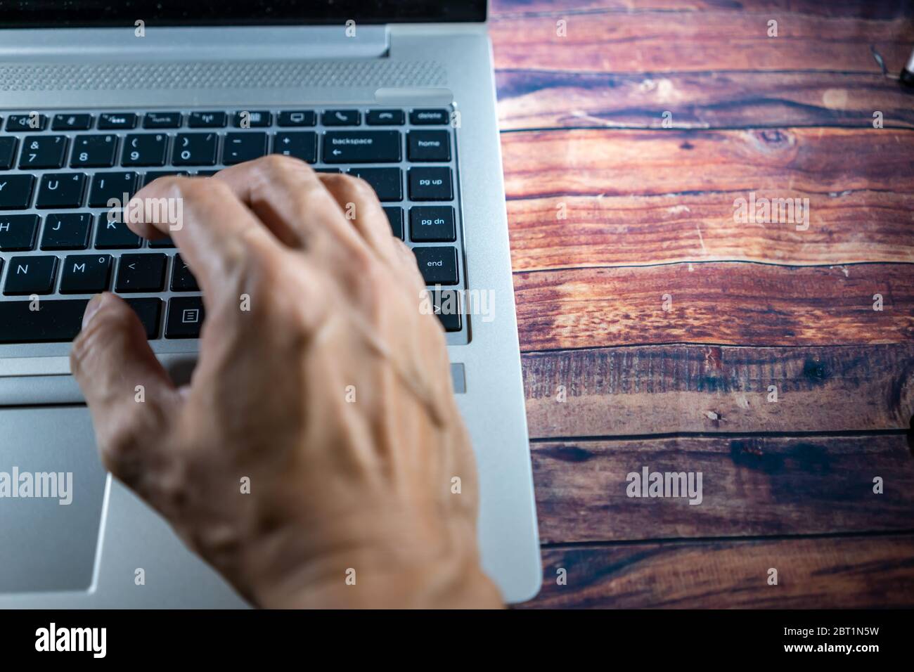 Laptop with a hand while typing or encoding. Business concept, office ...