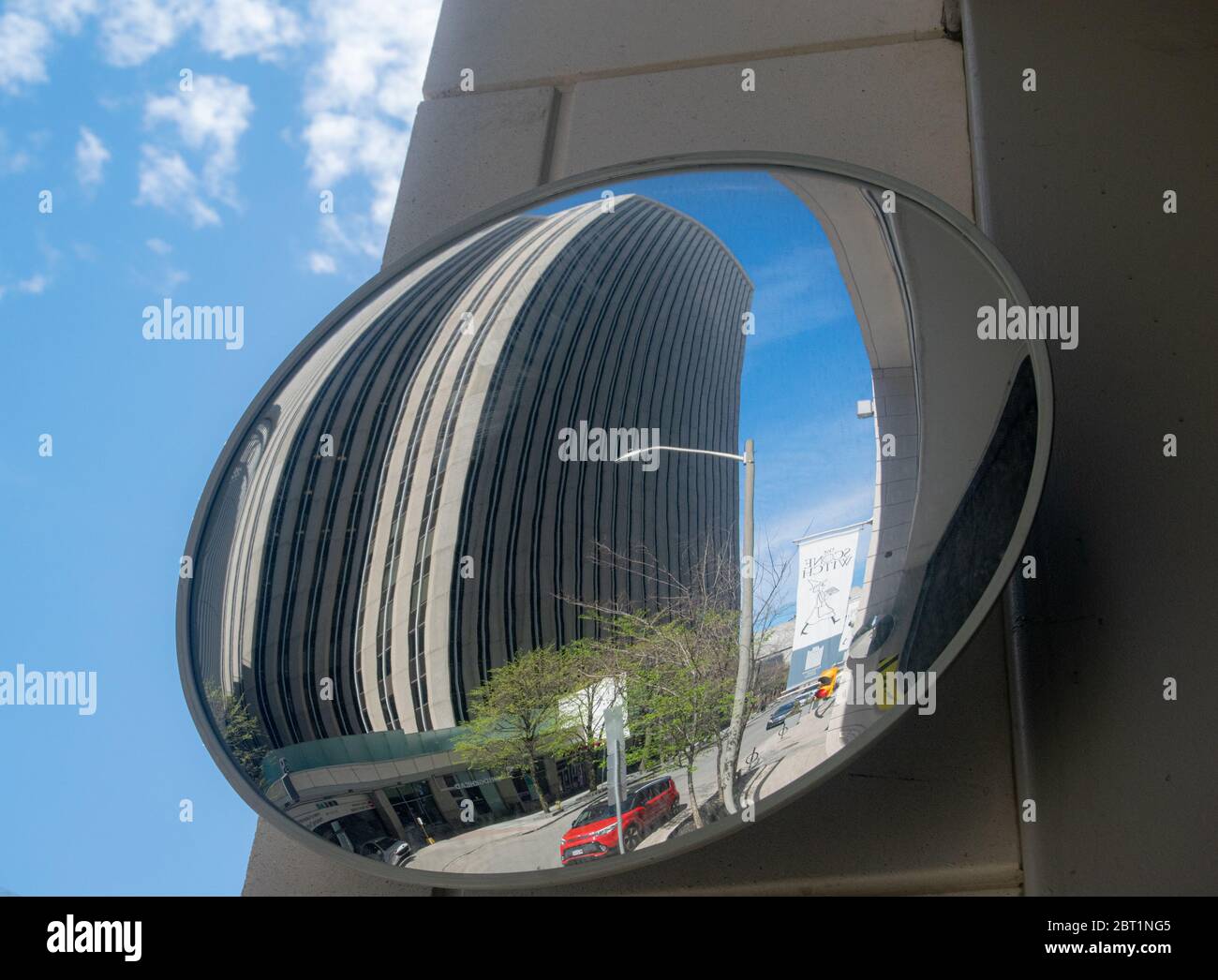 A modern office tower reflected on a round mirror Stock Photo - Alamy