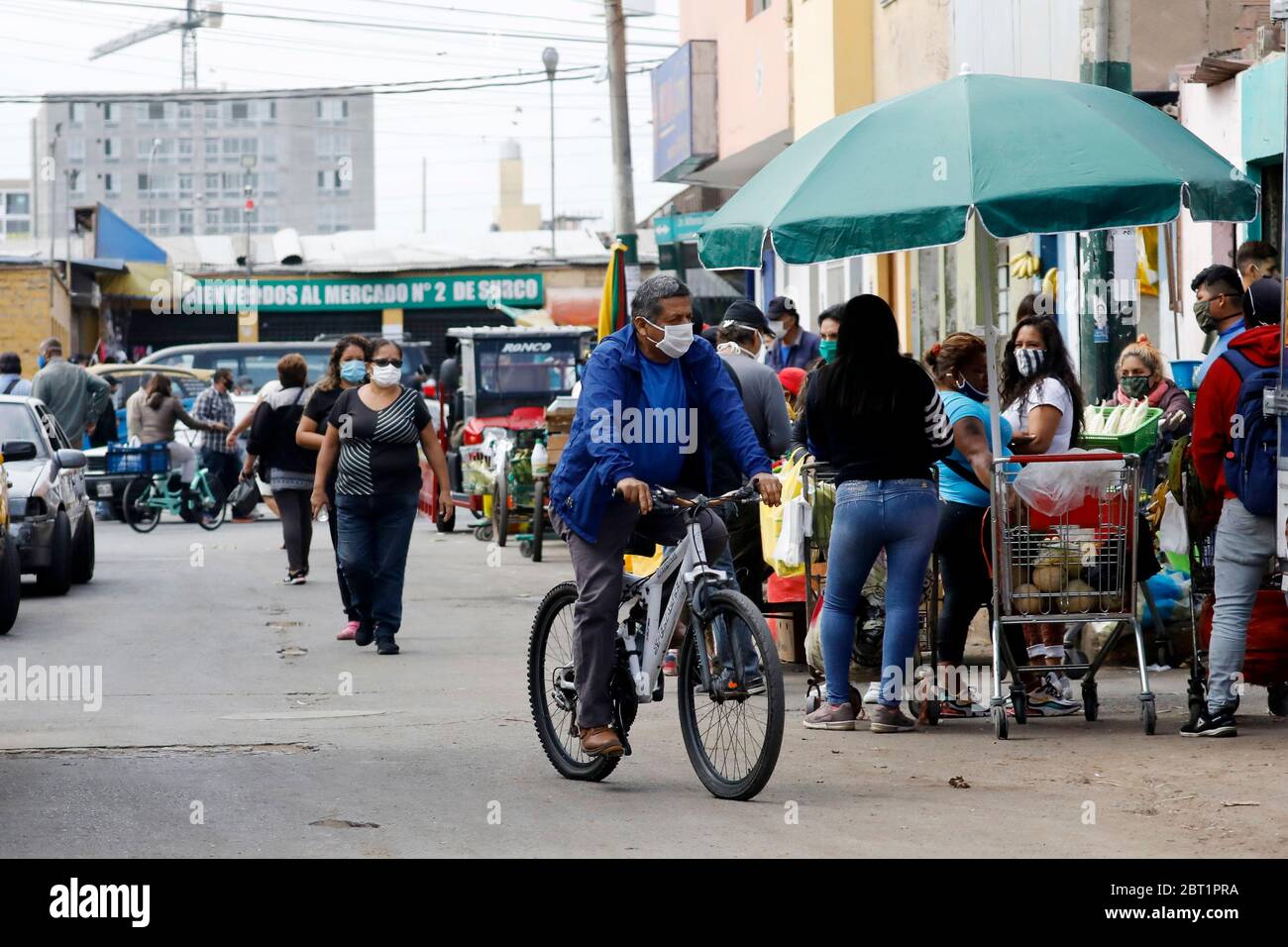 Lima, Peru. 21st May, 2020. People walk near street vendors at a street ...