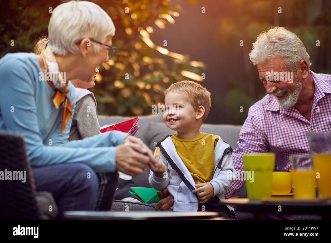 Happy grandparents enjoying with grandchild.Cheerful family spending ...