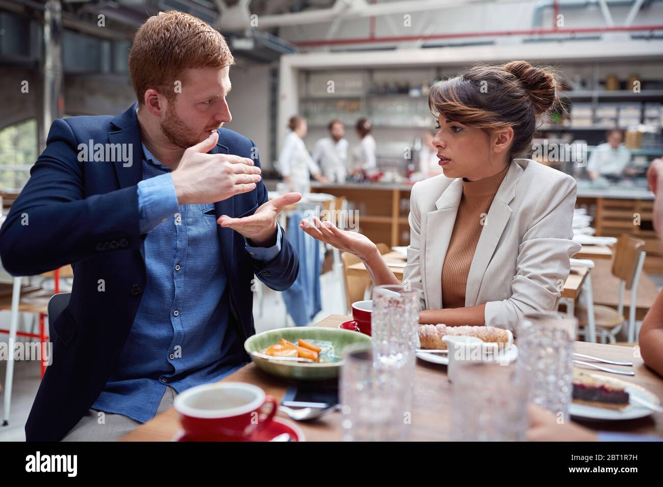 man and woman discussing at lunch. friends, colleagues, couple ...