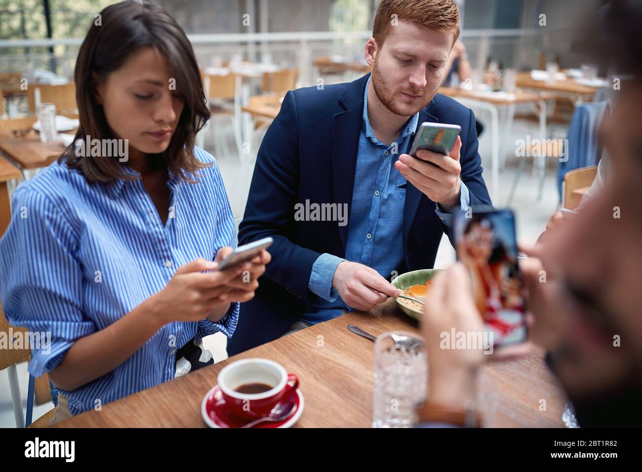 people at lunch using their cell phones. not present, social issues ...