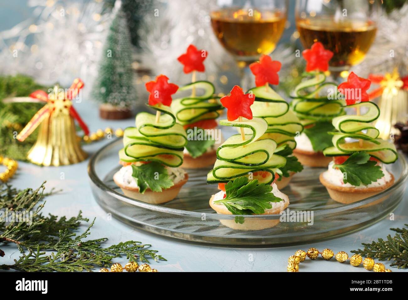 Festive canapes in the shape of Christmas trees made of cucumbers and ...