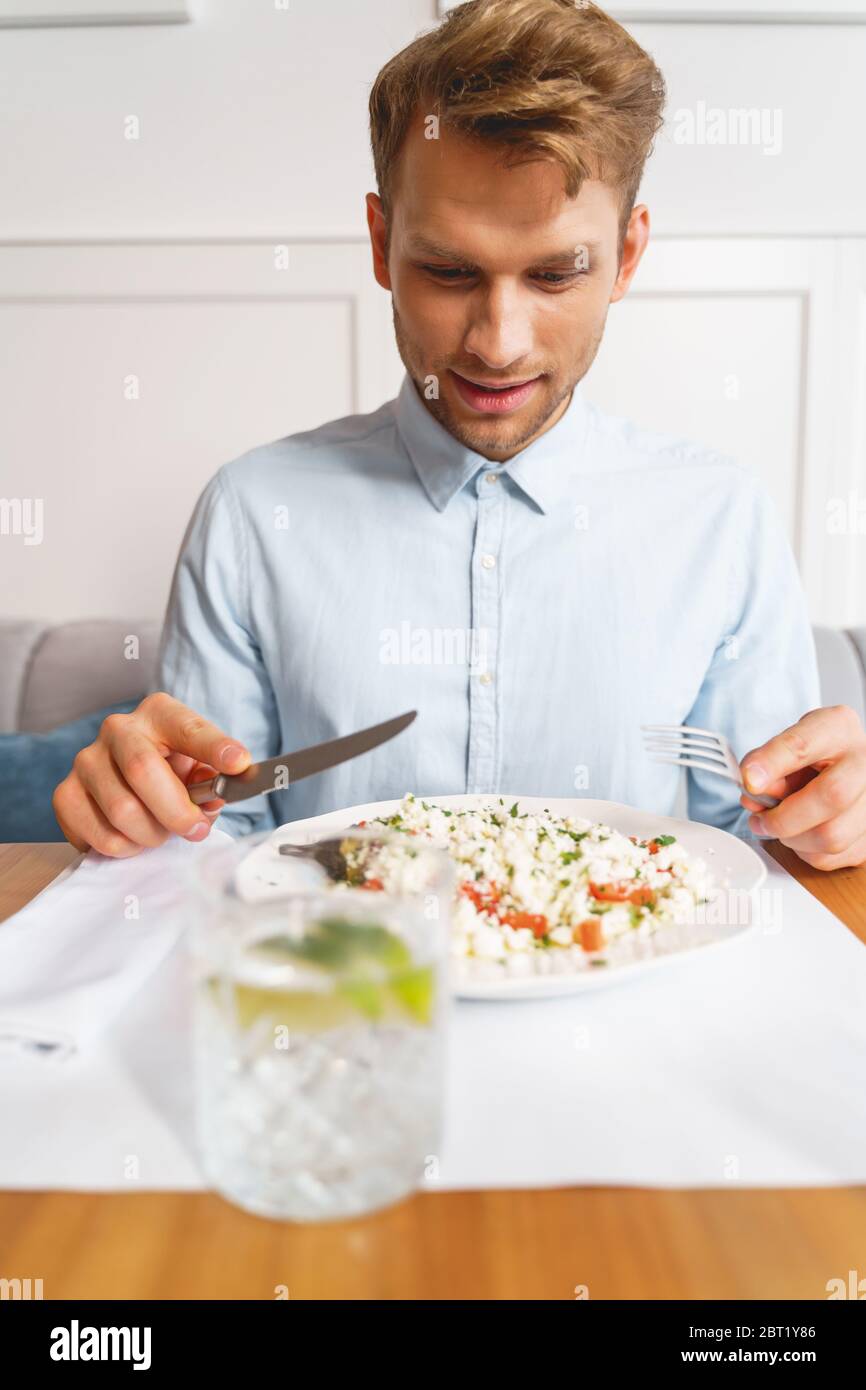 Handsome man eating fork knife hi-res stock photography and images - Alamy