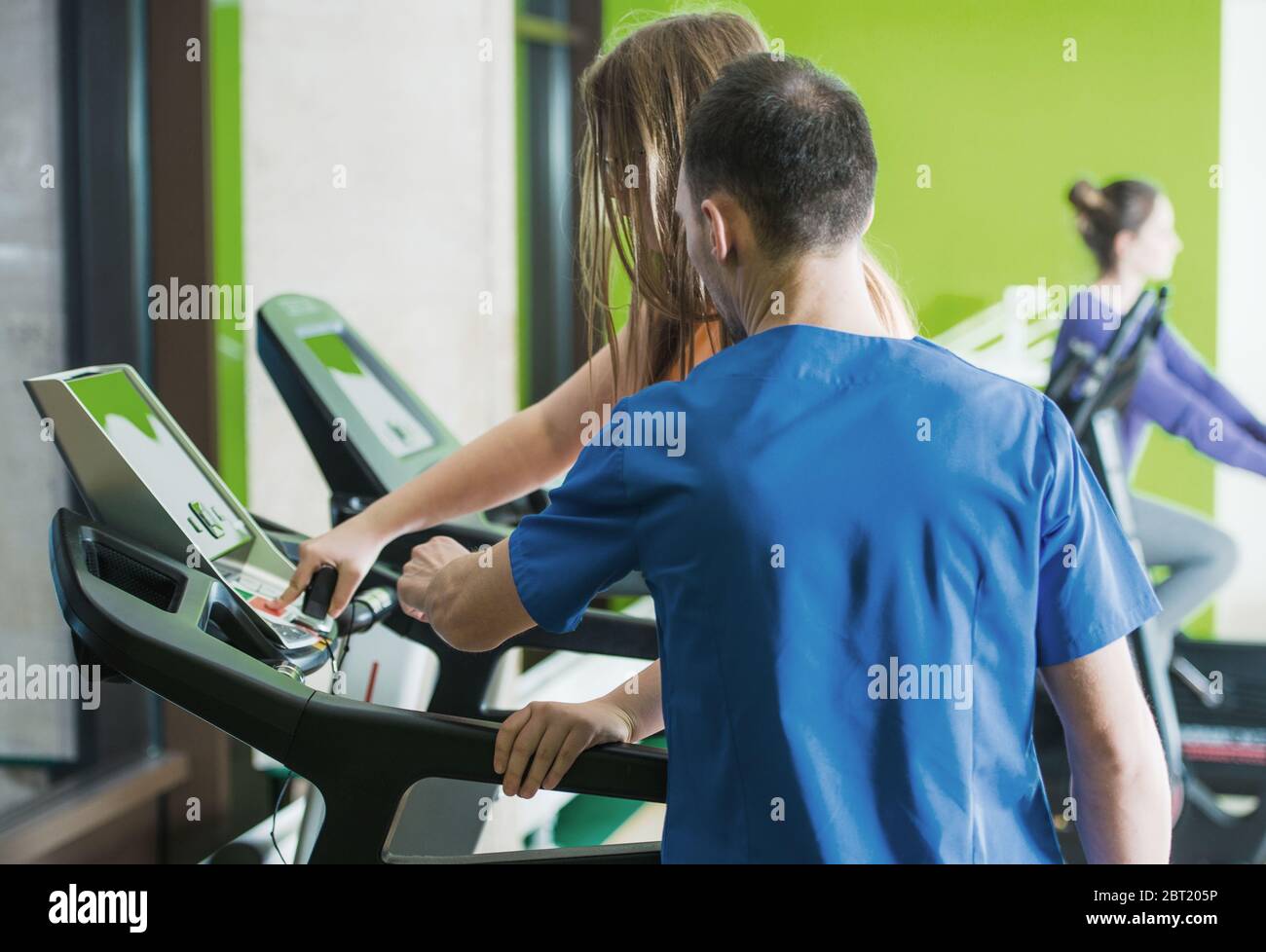 Male Physical Therapist Showing Young Female Patient How To Use ...