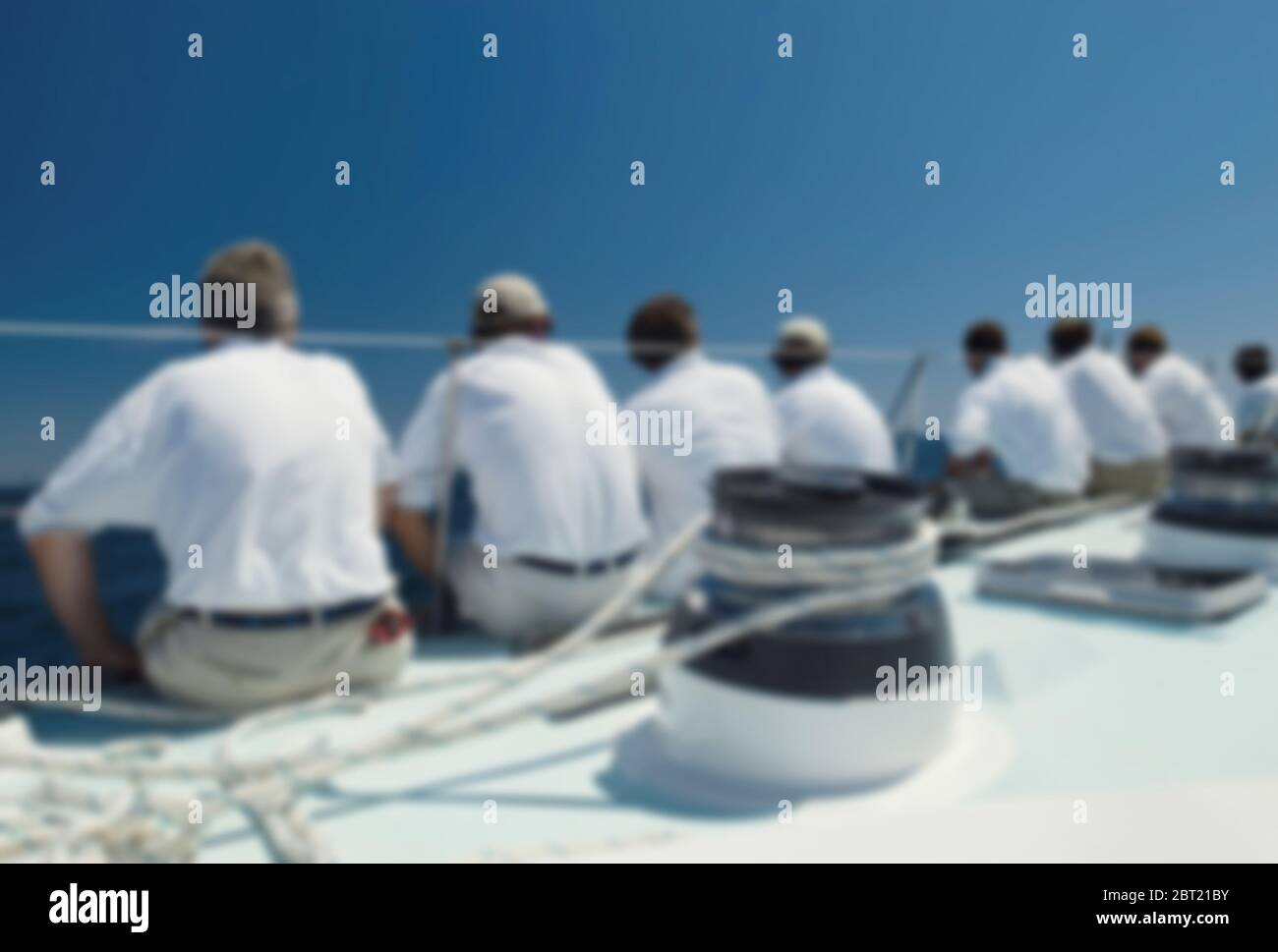 Blurred Rear view of sailing crew sitting on boat Stock Photo - Alamy