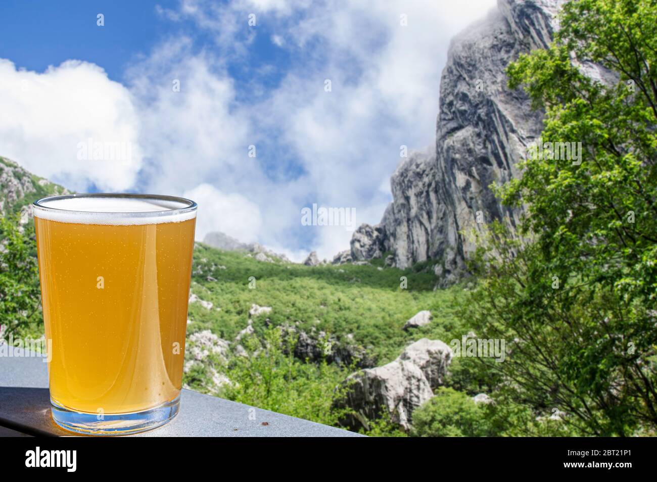 Glass of light beer with view of mountains in Croatia. Beautiful view ...