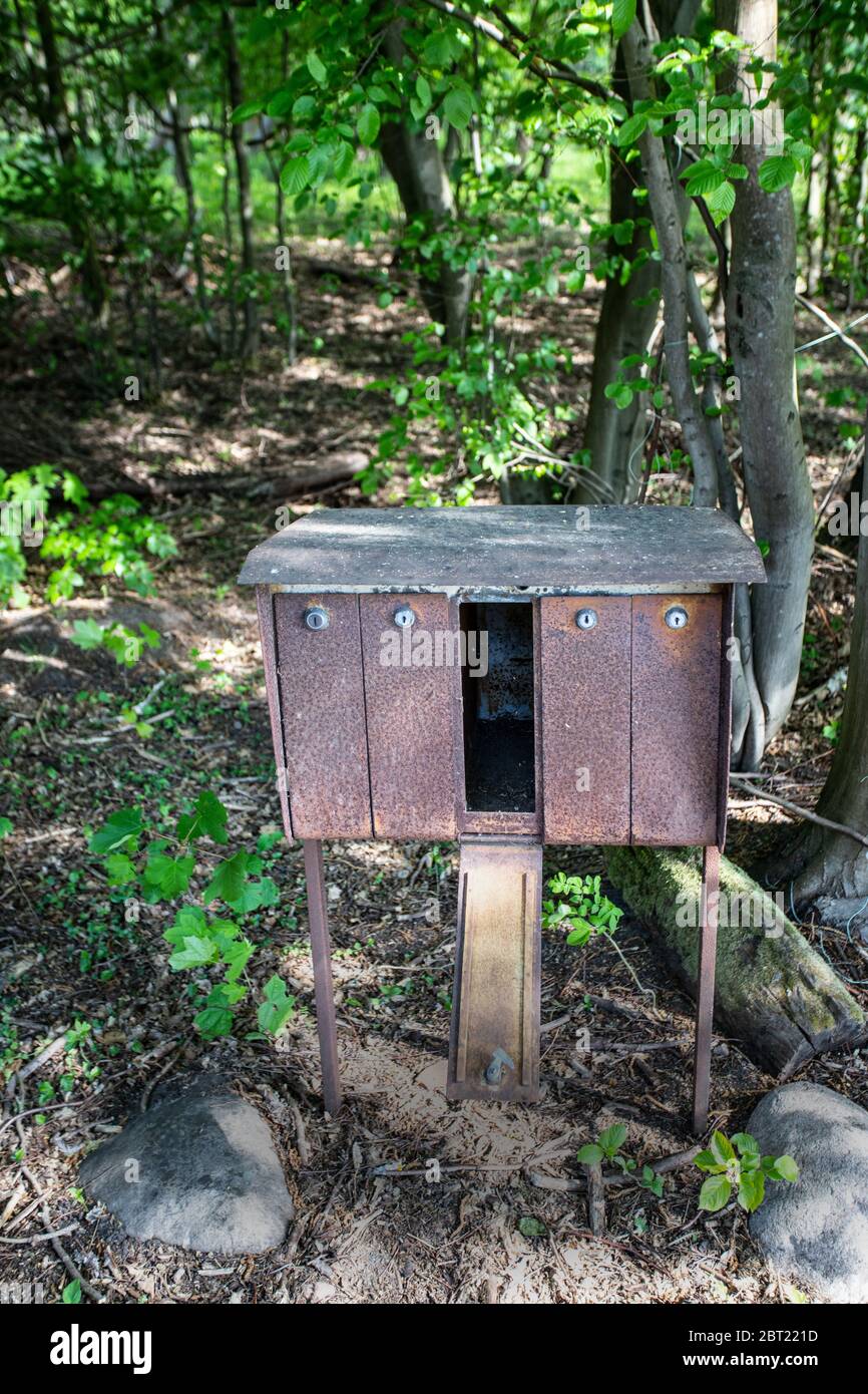 old rusty letterbox in the foresttradition Stock Photo - Alamy