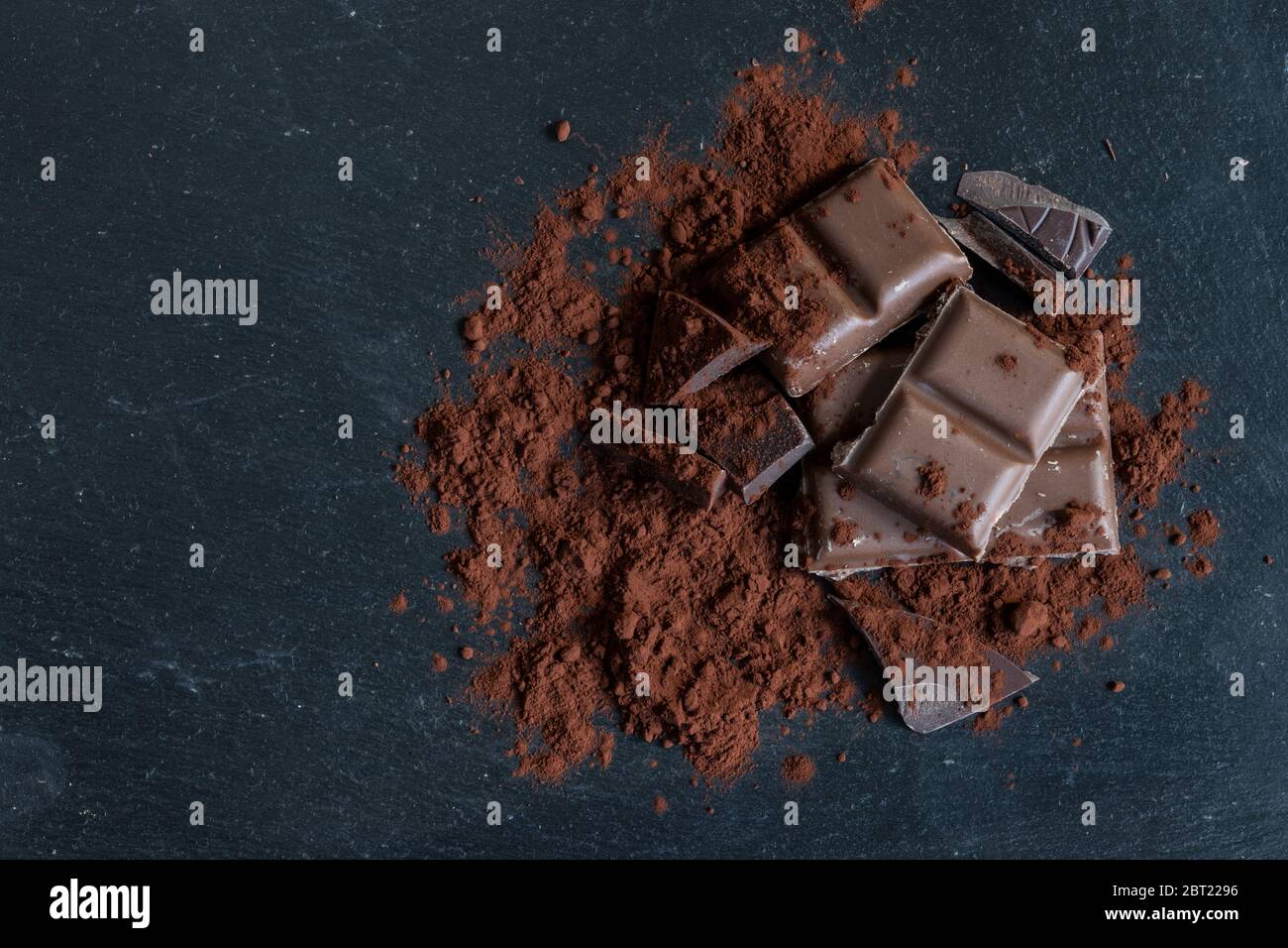broken chocolate with cacao-powder Stock Photo - Alamy
