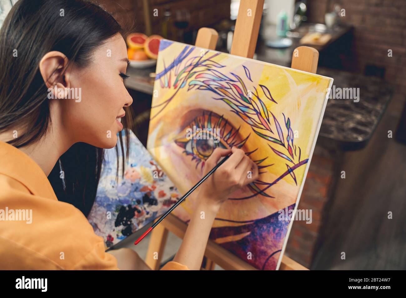 Beautiful female artist drawing picture with paints Stock Photo - Alamy