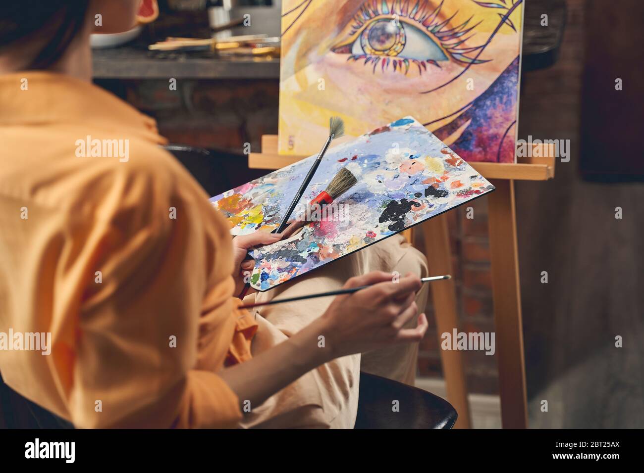 Female artist drawing picture with paints at home Stock Photo - Alamy