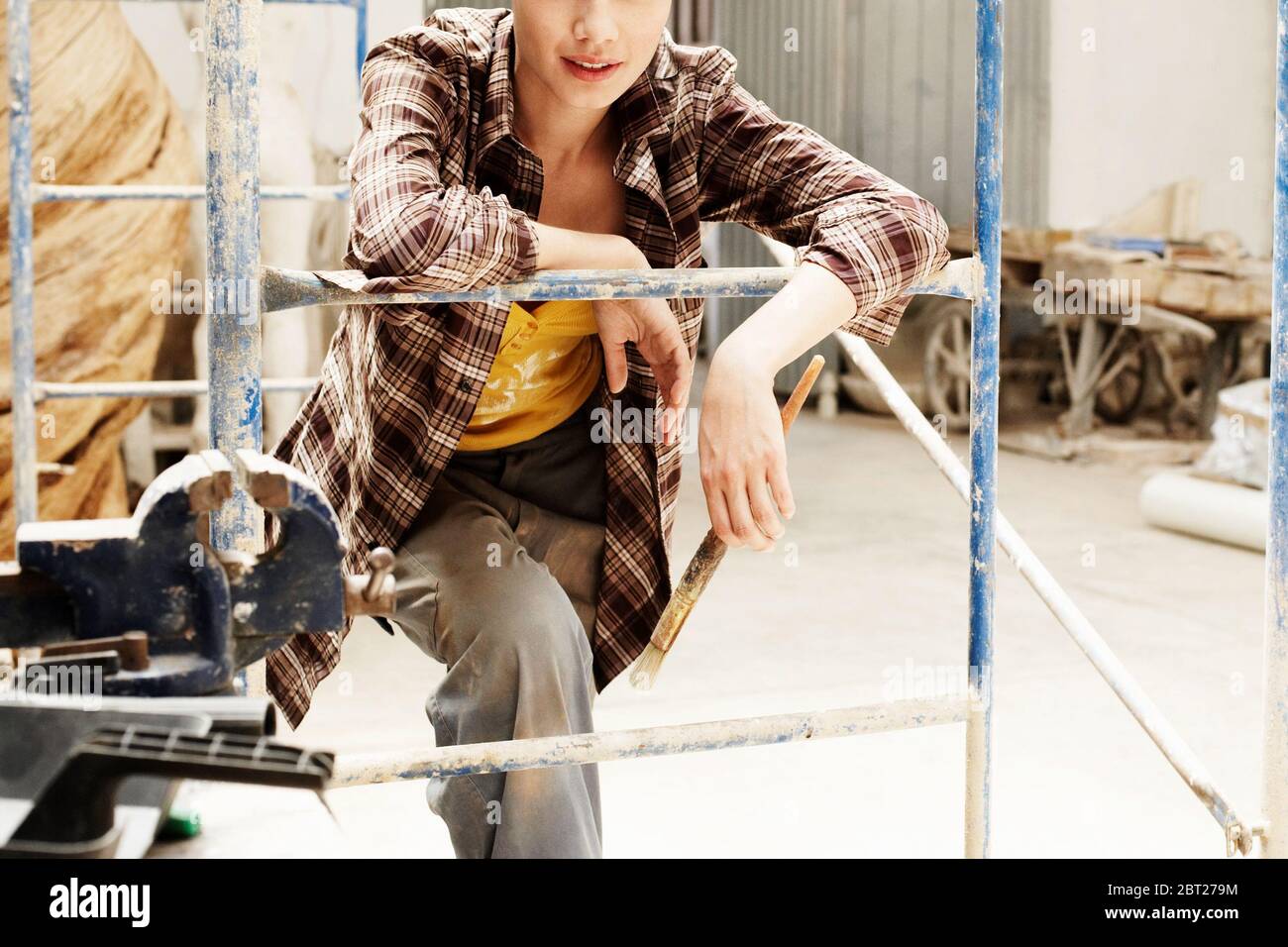 Young construction builder Woman Behind Scaffolding Stock Photo - Alamy