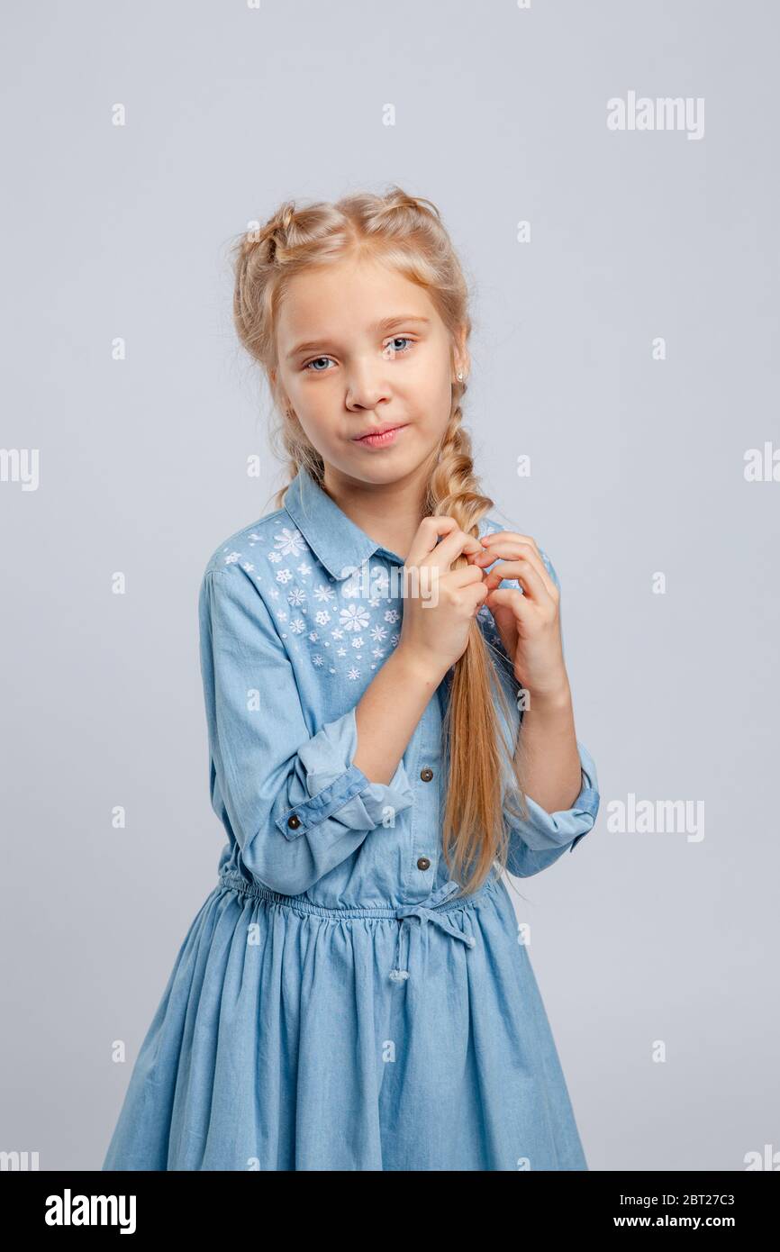 long-haired girl braids her hair Stock Photo - Alamy