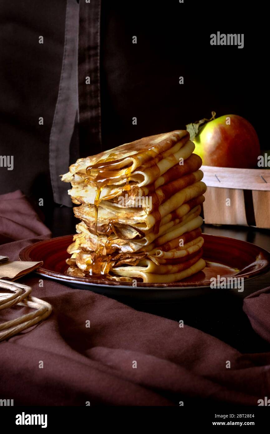 Traditional Pancakes with Apples and packaging carton bag on the black ...