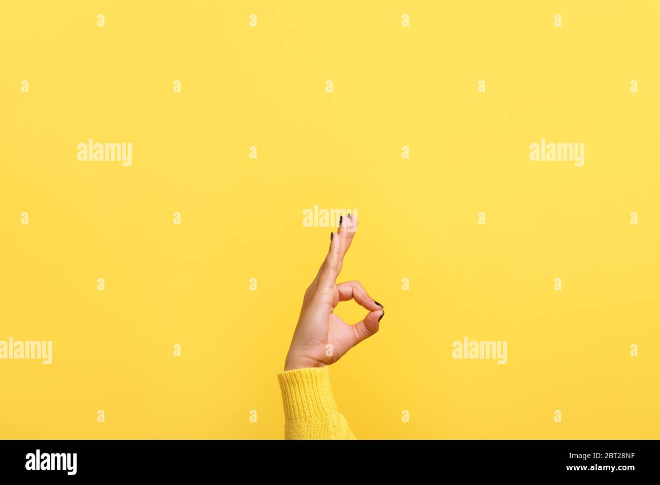hand ok sign over trend yellow background Stock Photo - Alamy