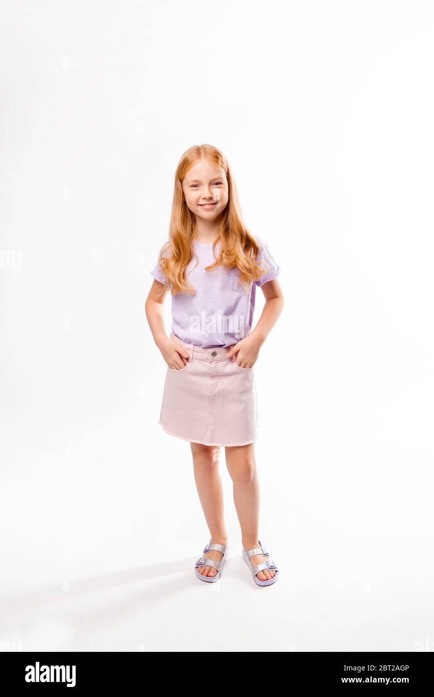 cute red-haired girl in ordinary clothes is standing and smiling Stock ...