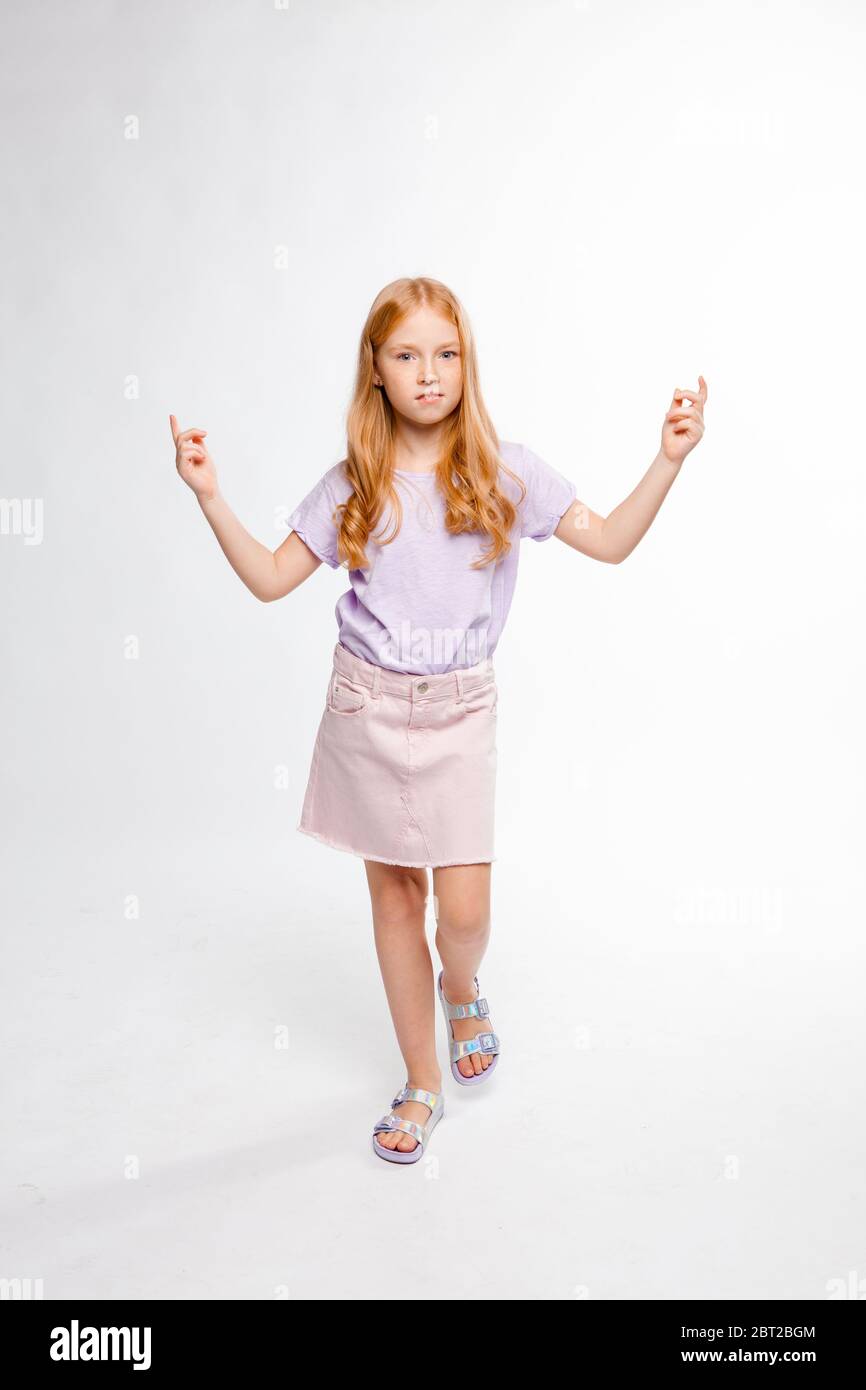 cute red-haired long-haired girl in daily clothes is angry and raises ...