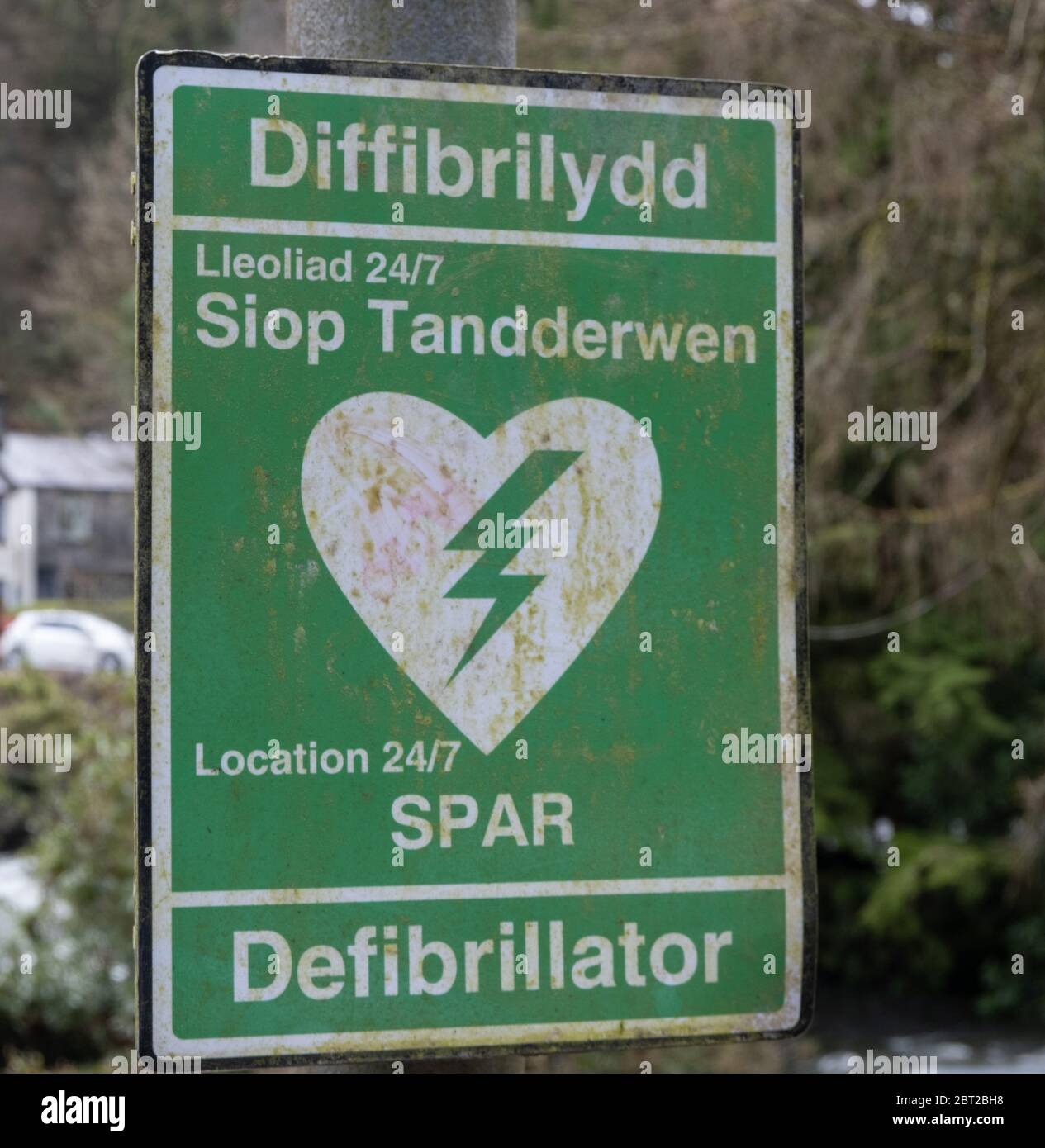 bilingual rusting sign indicating location of defibrillator in Betwys y ...