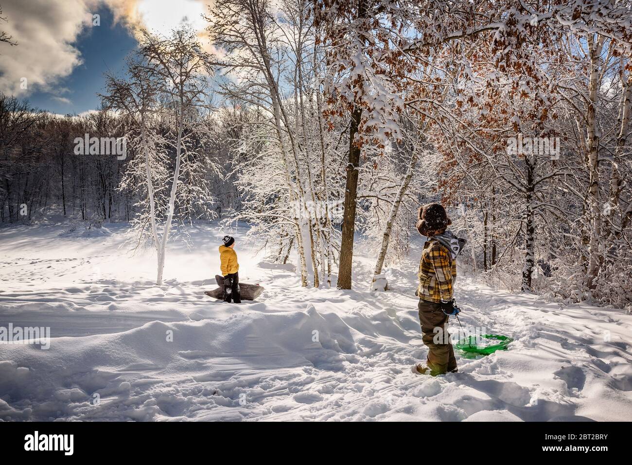 Two boys sledding in the snow, USA Stock Photo - Alamy