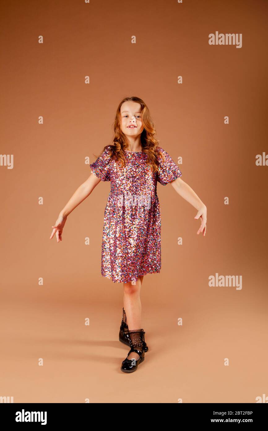 little girl in sequin dress is dancing Stock Photo - Alamy