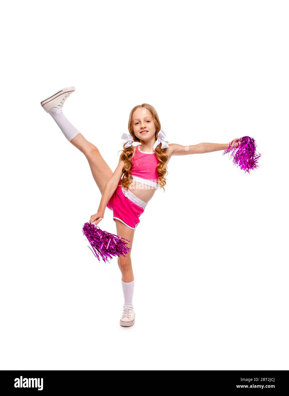 long-haired girl in a pink top and cheerleader clothes dancing with ...