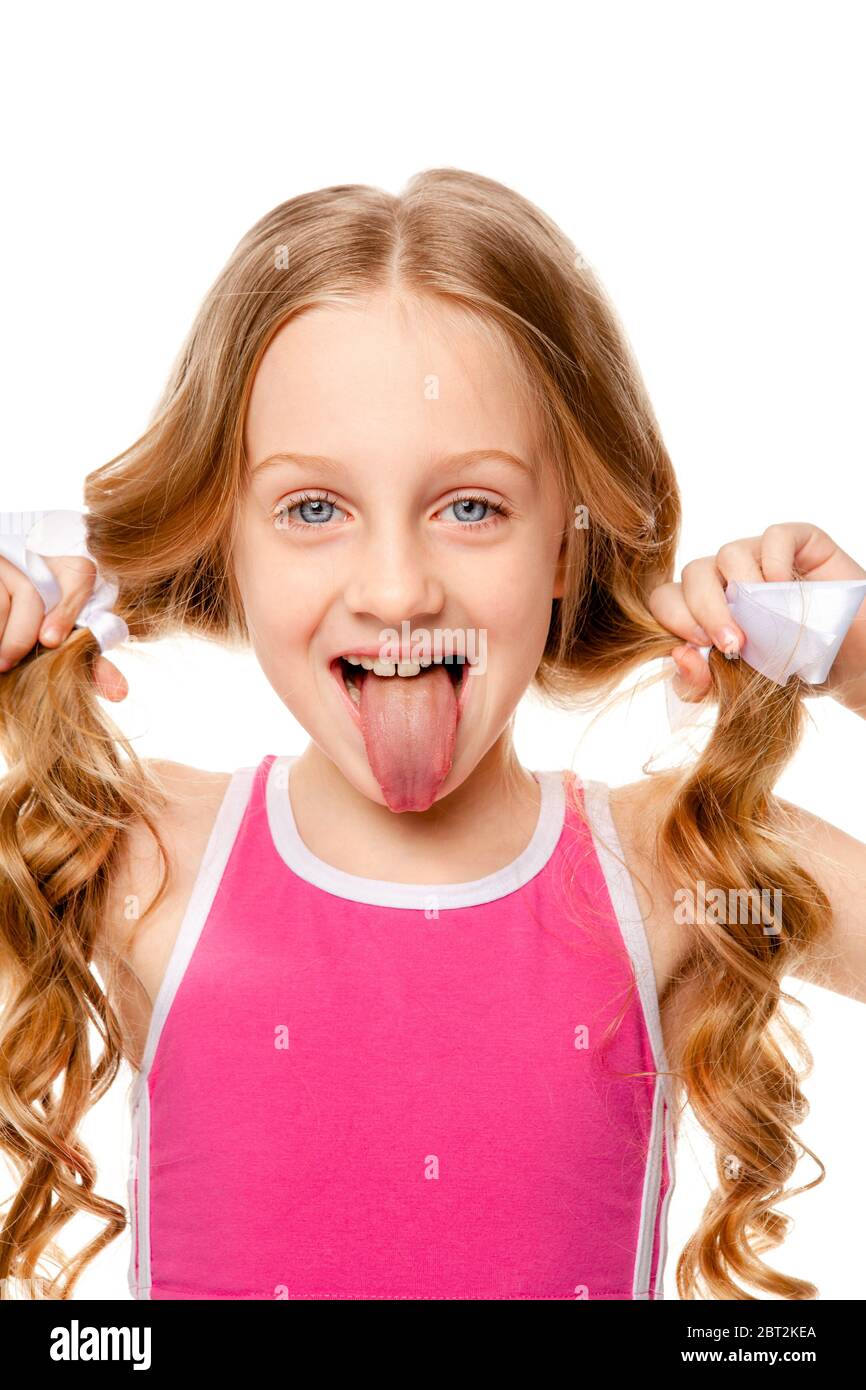 girl in a pink top shows tongue Stock Photo - Alamy